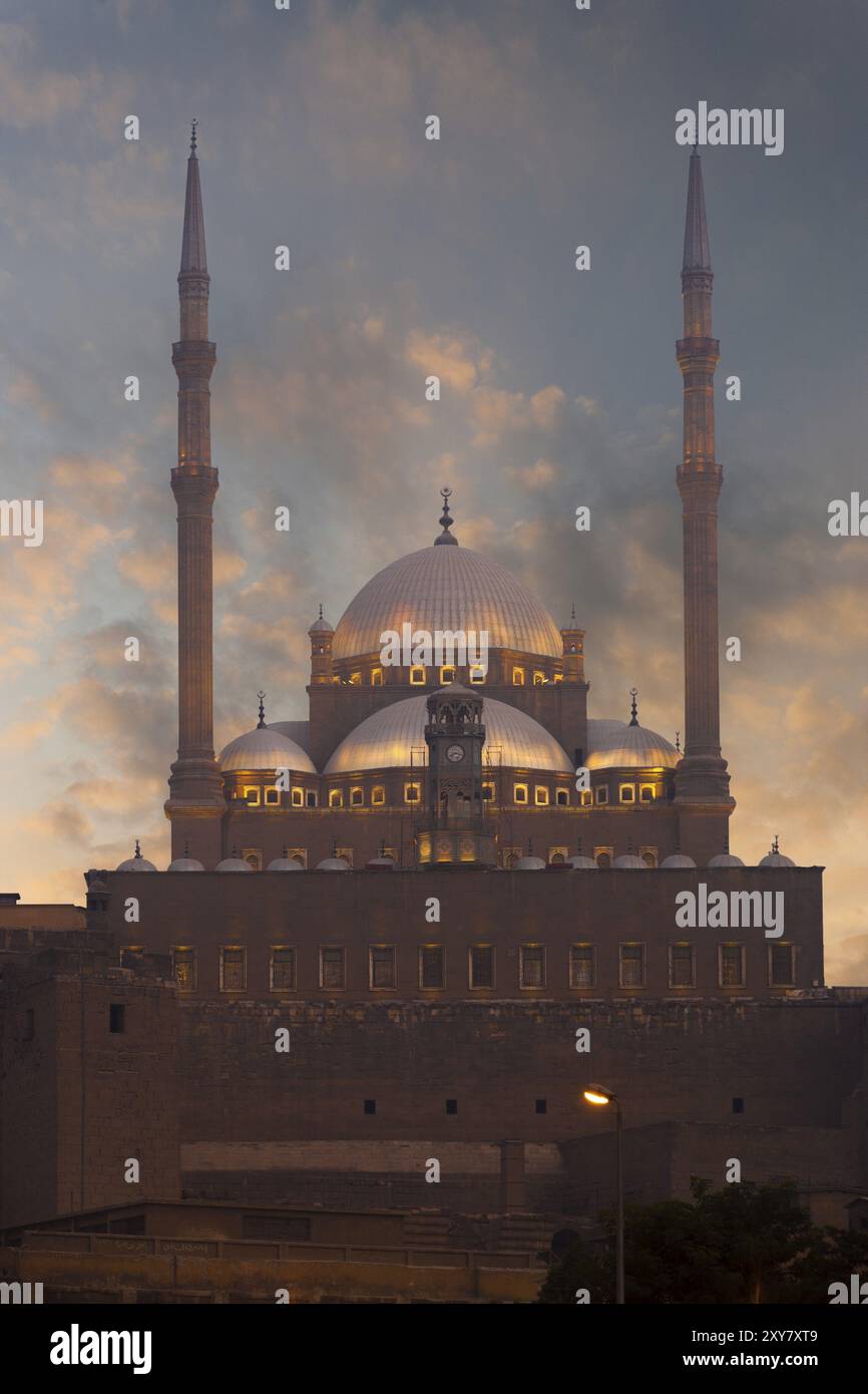 A beautiful fiery sunset behind the minarets of the historic citadel in ...