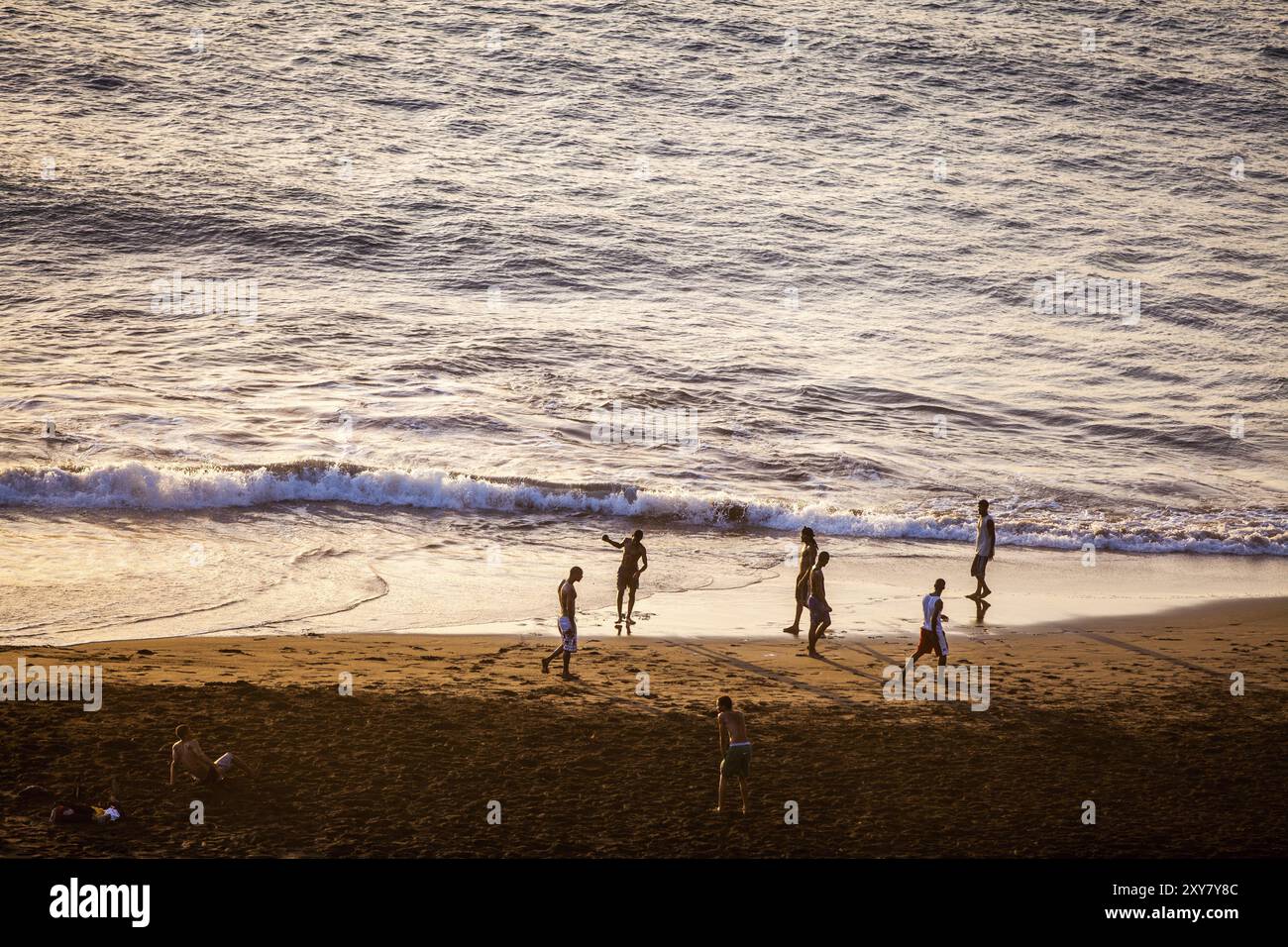 A group of young men having fun on the beach Stock Photo - Alamy
