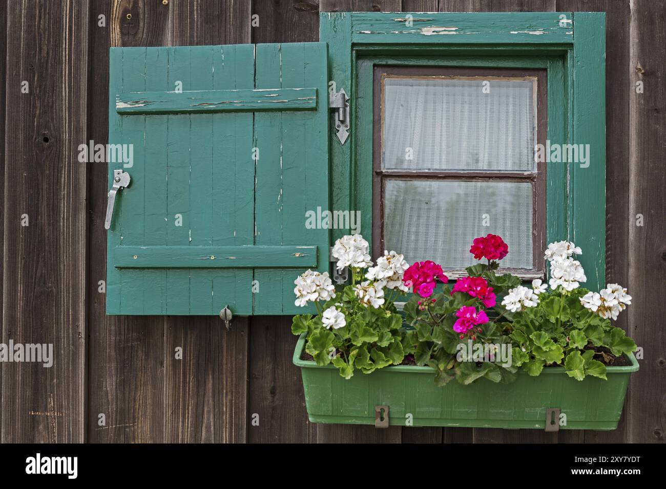 Small window at a mountain hut with geraniums Stock Photo - Alamy