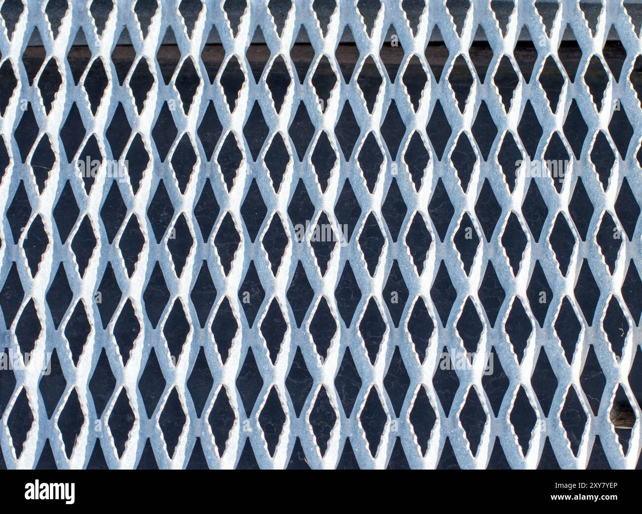 A metal grate floor creates a nice background or texture pattern with ...