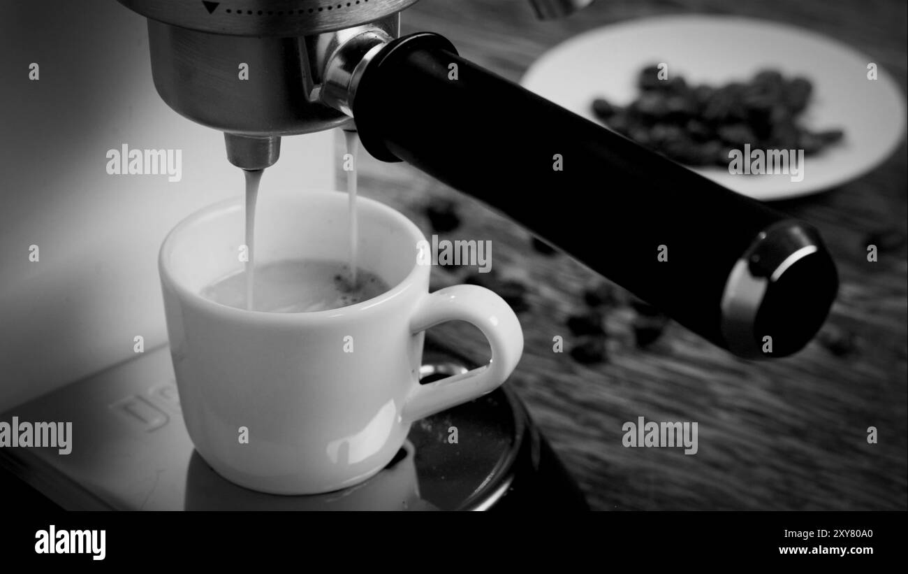 Close-up of Americano pouring from the coffee machine into a cup ...
