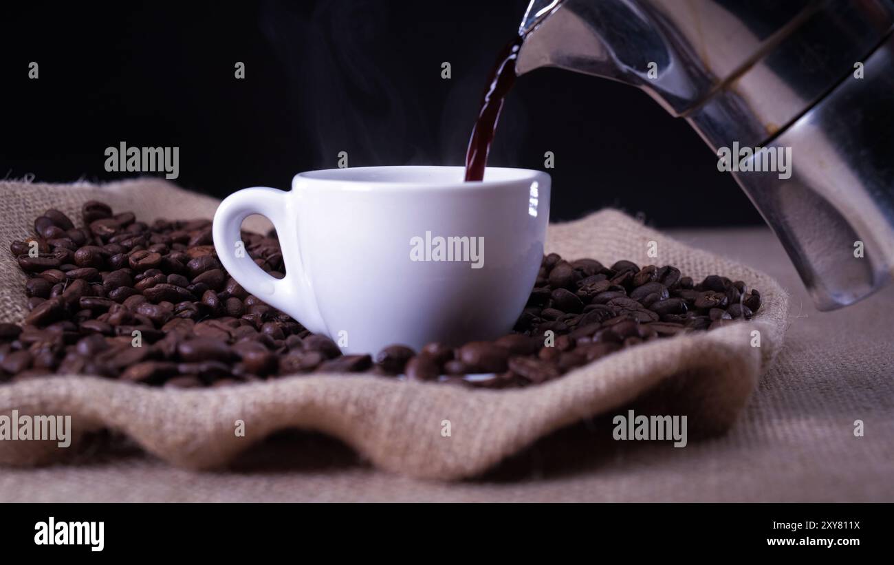 Close-up of Americano pouring from the coffee machine into a cup ...