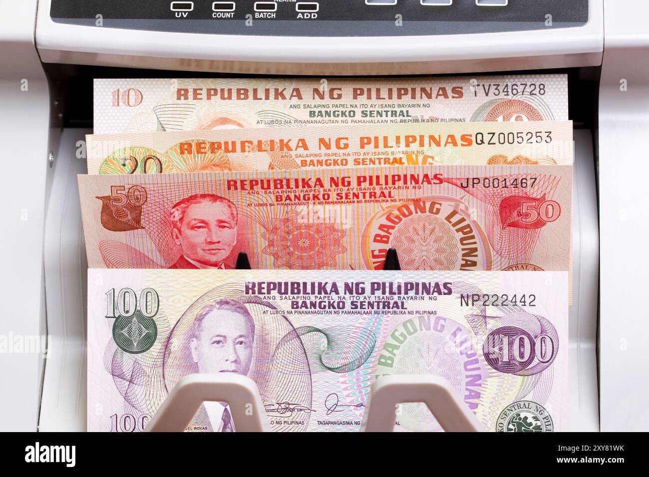 Philippine money - peso in the counting machine Stock Photo - Alamy