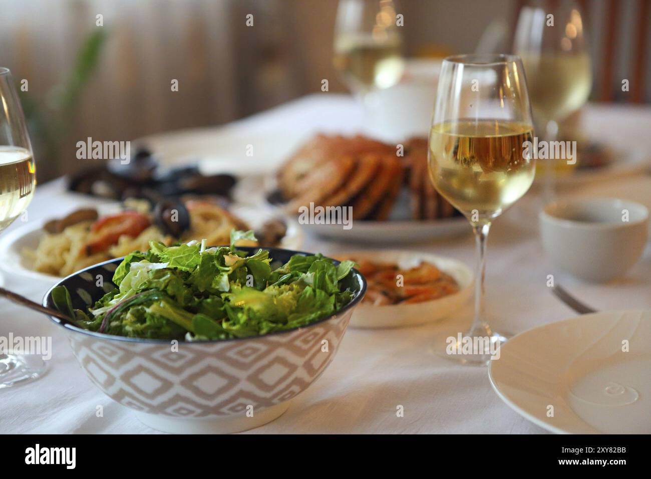 People fine dining seafood and white wine on the table Stock Photo - Alamy