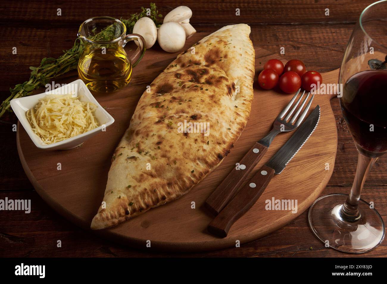 Calzone, traditional Italian preparation accompanied by spices and red ...