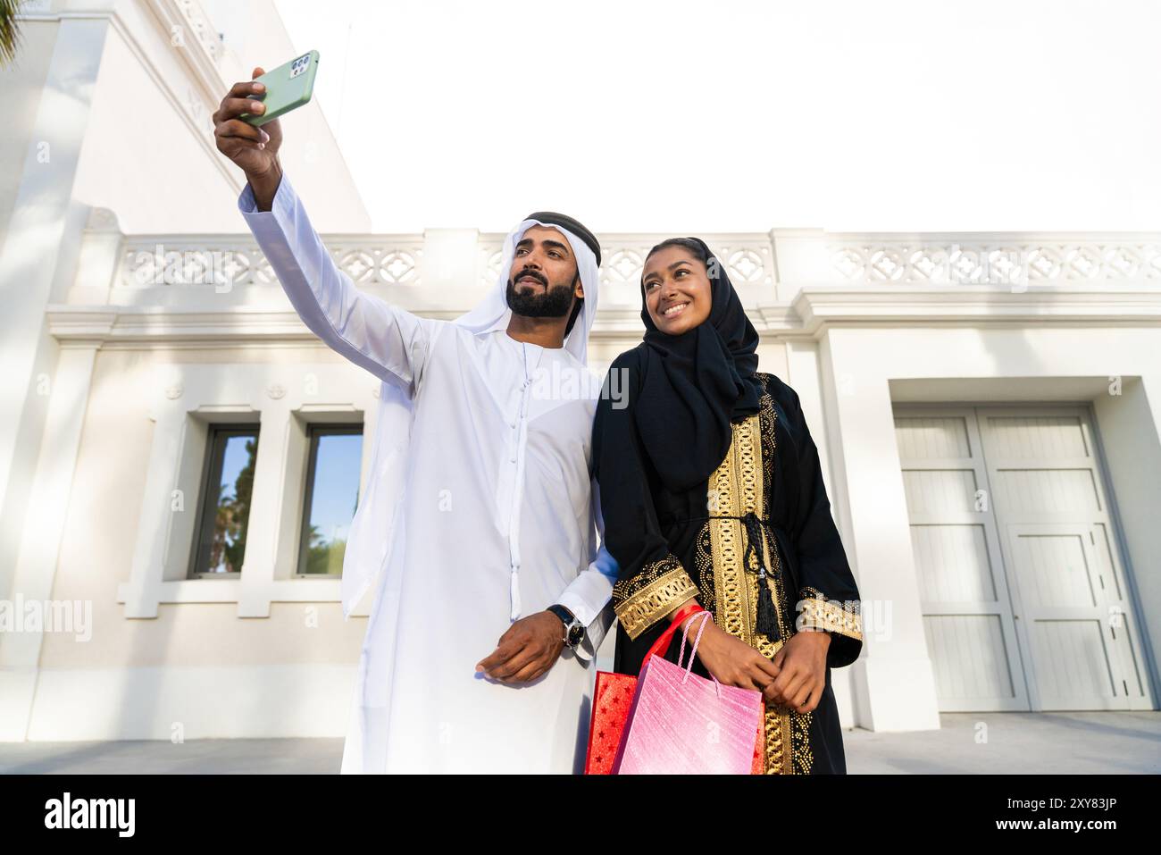 Traditional arab couple wearing emirati clothing dating outdoors - Middle-eastern married woman ...