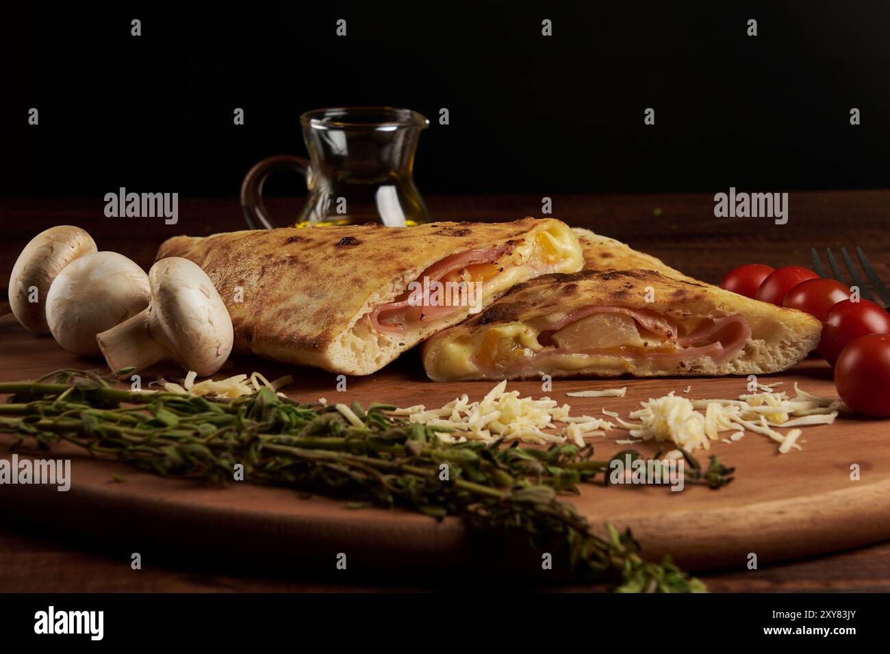 Calzone, traditional Italian preparation accompanied by spices and red ...