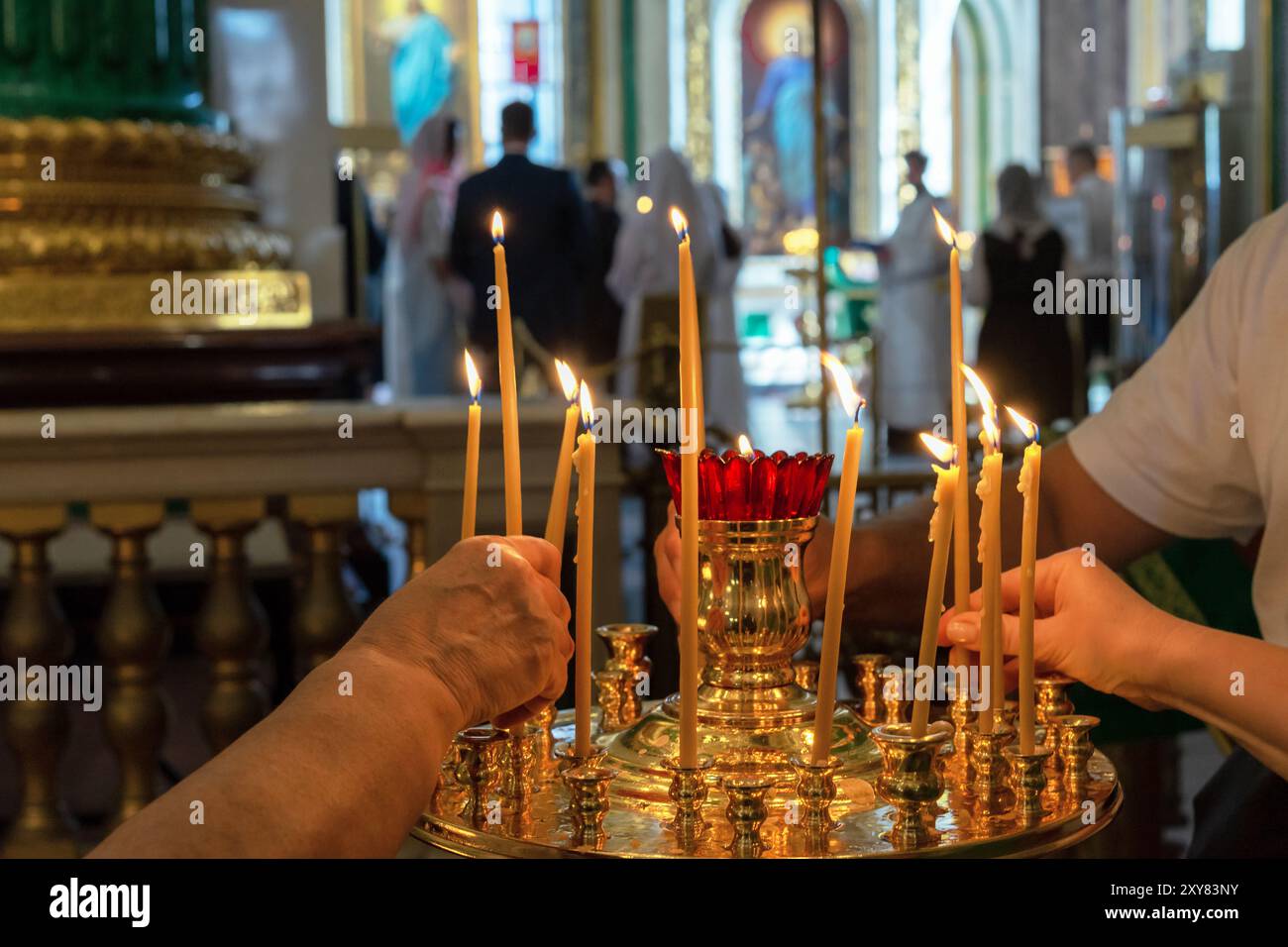 People light prayer candles during church services Stock Photo - Alamy