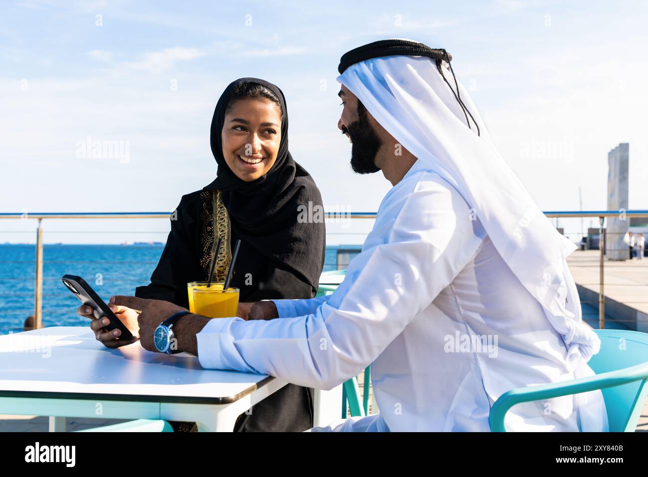 Traditional arab couple wearing emirati clothing dating outdoors - Middle-eastern married woman ...
