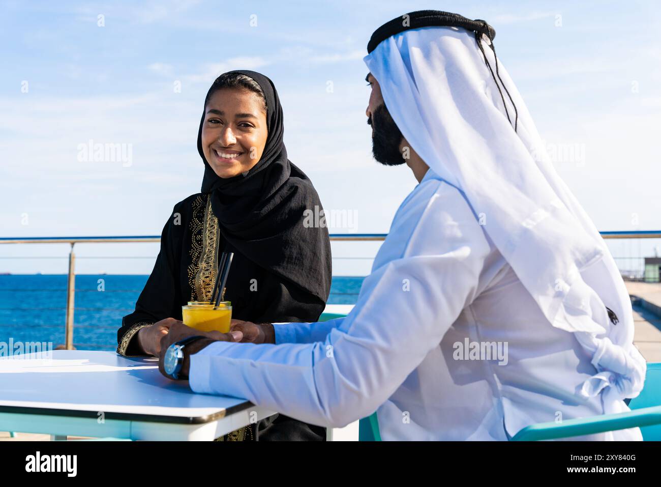 Traditional arab couple wearing emirati clothing dating outdoors - Middle-eastern married woman ...