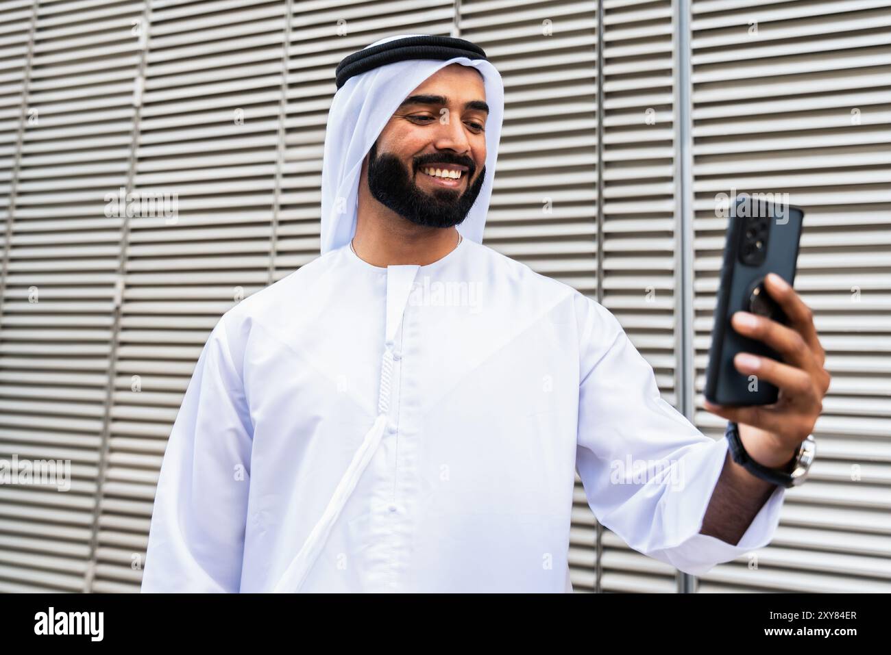 Portrait of handsome arab businessman wearing traditional emirati ...