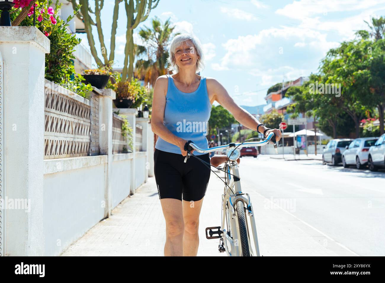 Beautiful happy senior woman cycling during summertime - Mature adult ...