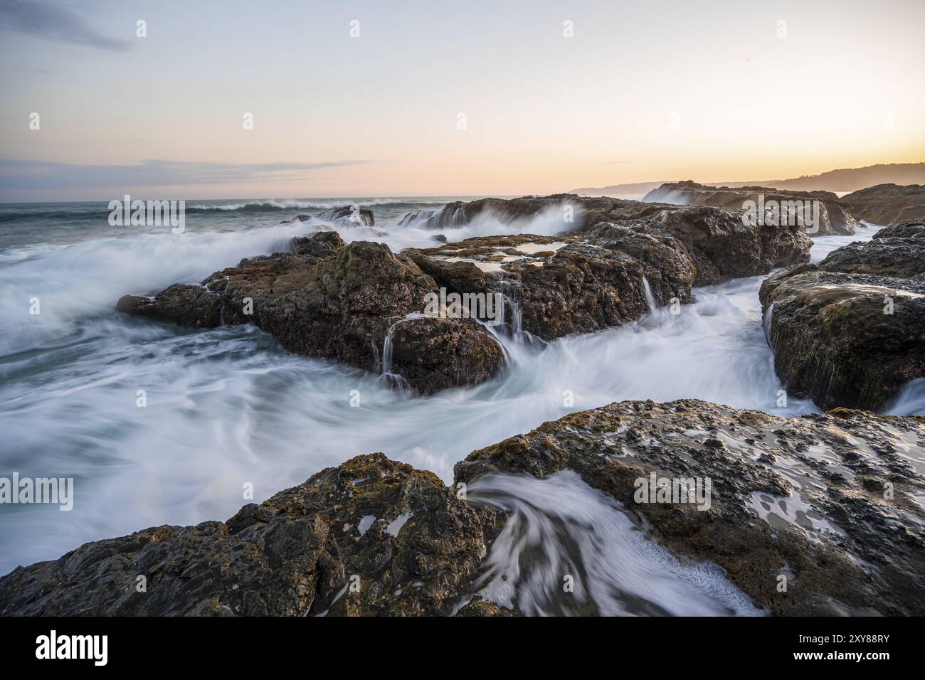 Waves washing over rocks by the sea, long exposure, coastal landscape ...