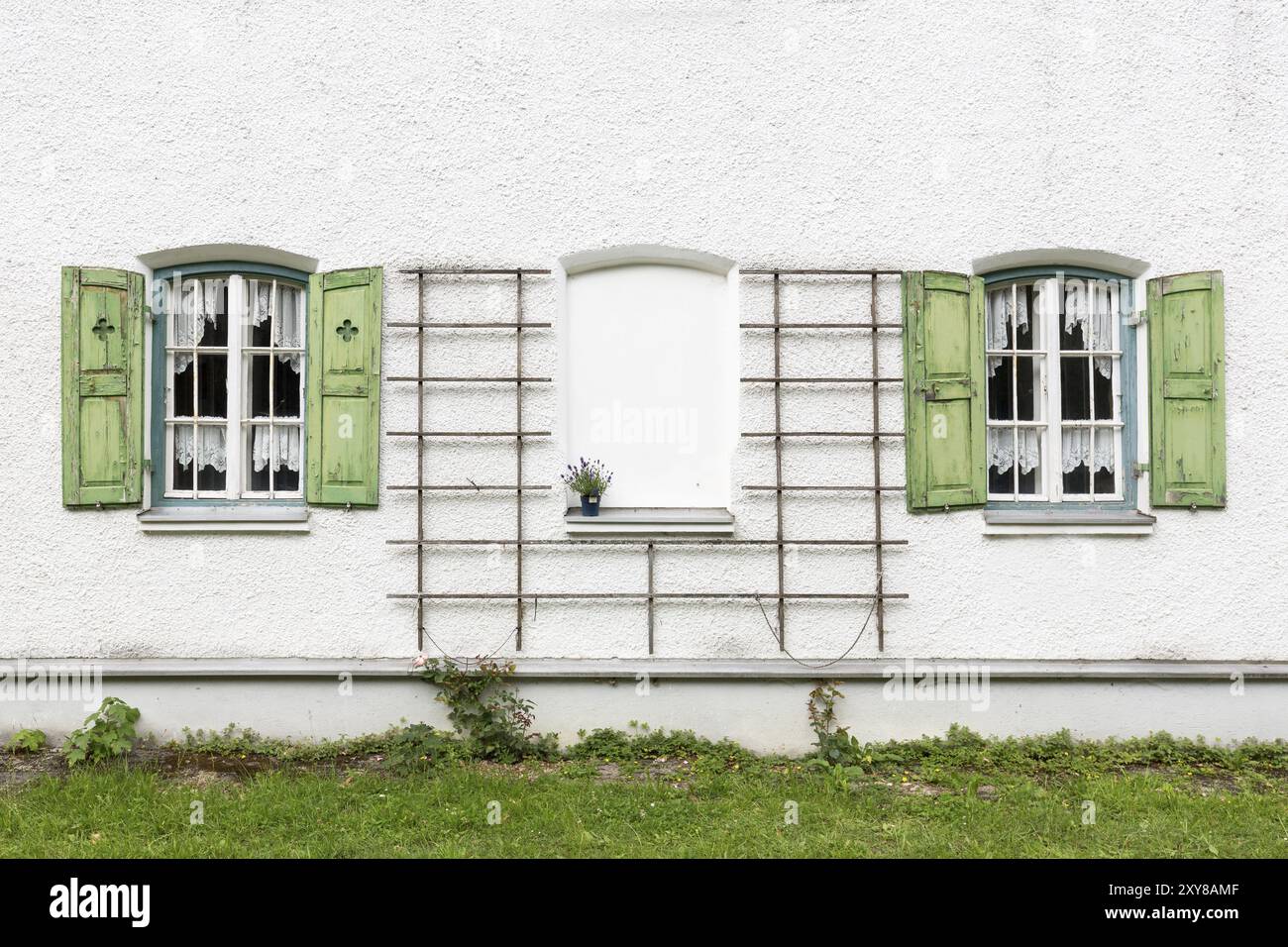 Two windows with window panelling on an old house Stock Photo - Alamy