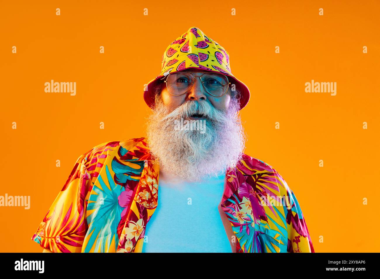 Senior old man tourist with gray beard wearing tropical shirt portrait ...
