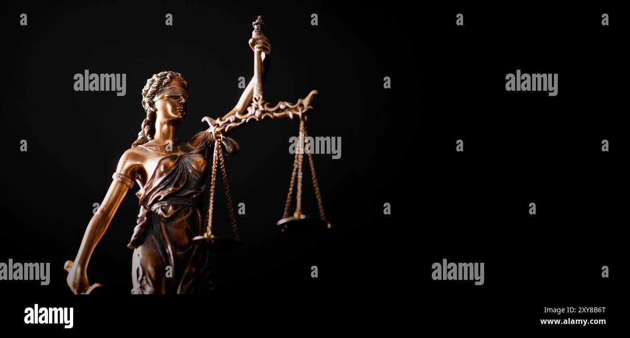 Blind justice symbol on a metallic statue on a dark background, copy ...