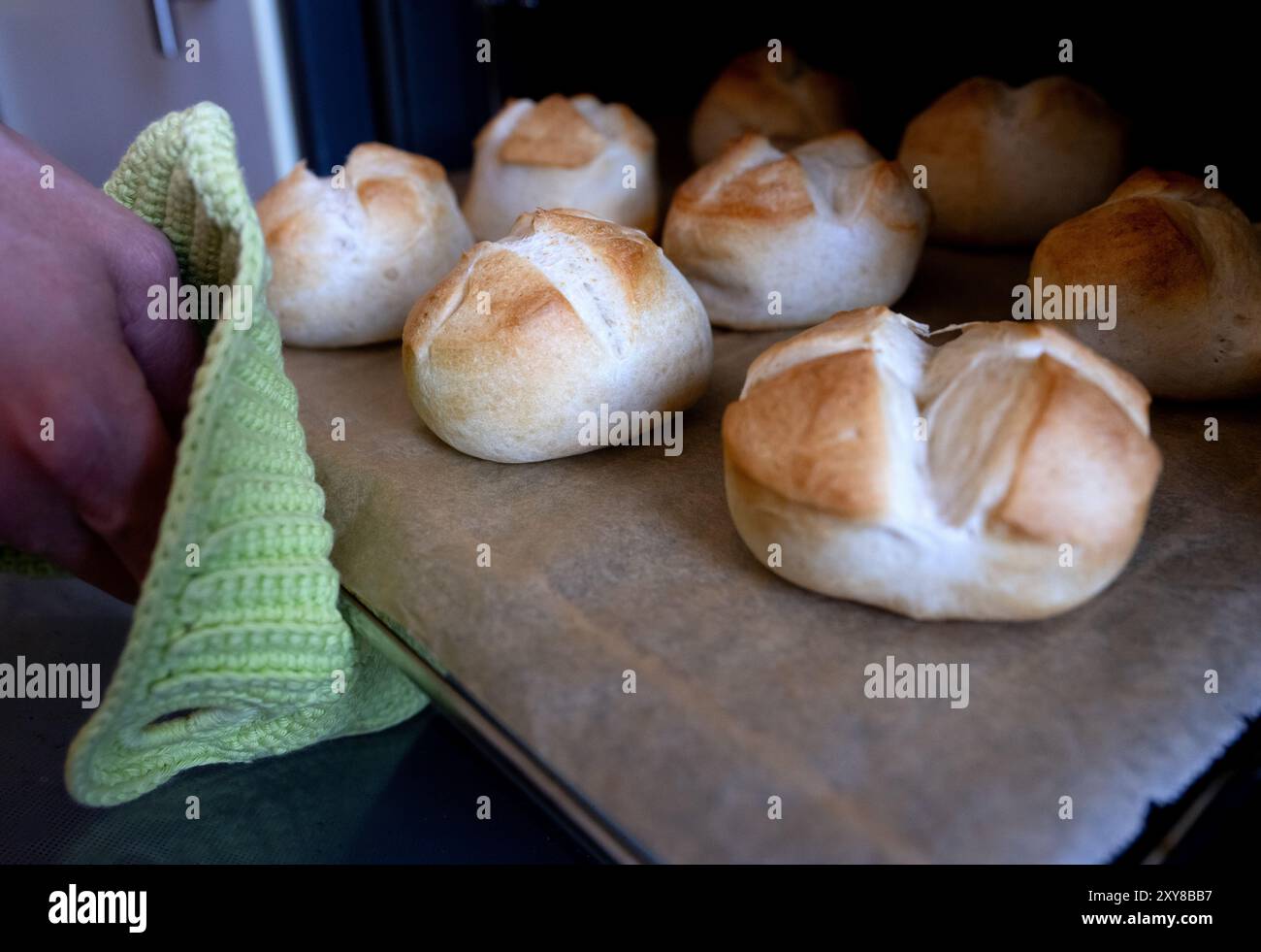 Munich, Germany. 28th Aug, 2024. A woman holds a freshly baked bread ...