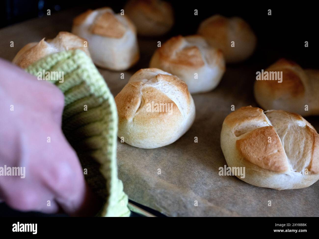 Munich, Germany. 28th Aug, 2024. A woman holds a freshly baked bread ...