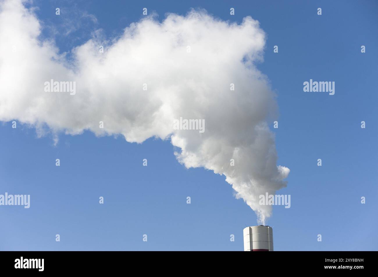 White smoke out of a smokestack in front of blue sky Stock Photo - Alamy