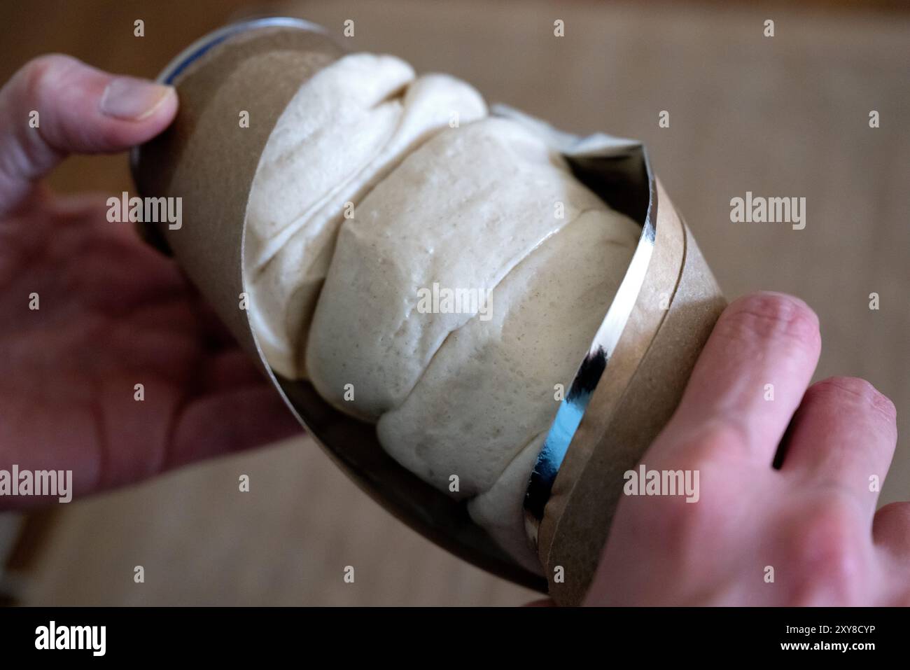 Munich, Germany. 28th Aug, 2024. A woman opens a tin of dough for baked ...
