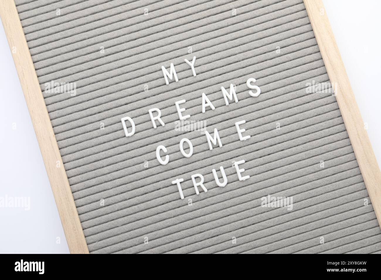 Letter board with phrase My dreams come true on white background, top ...
