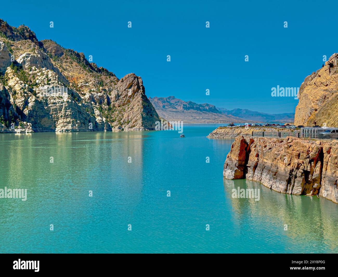 Buffalo Bill Dam Reservoir with boat & visitor cars in the parking lot ...