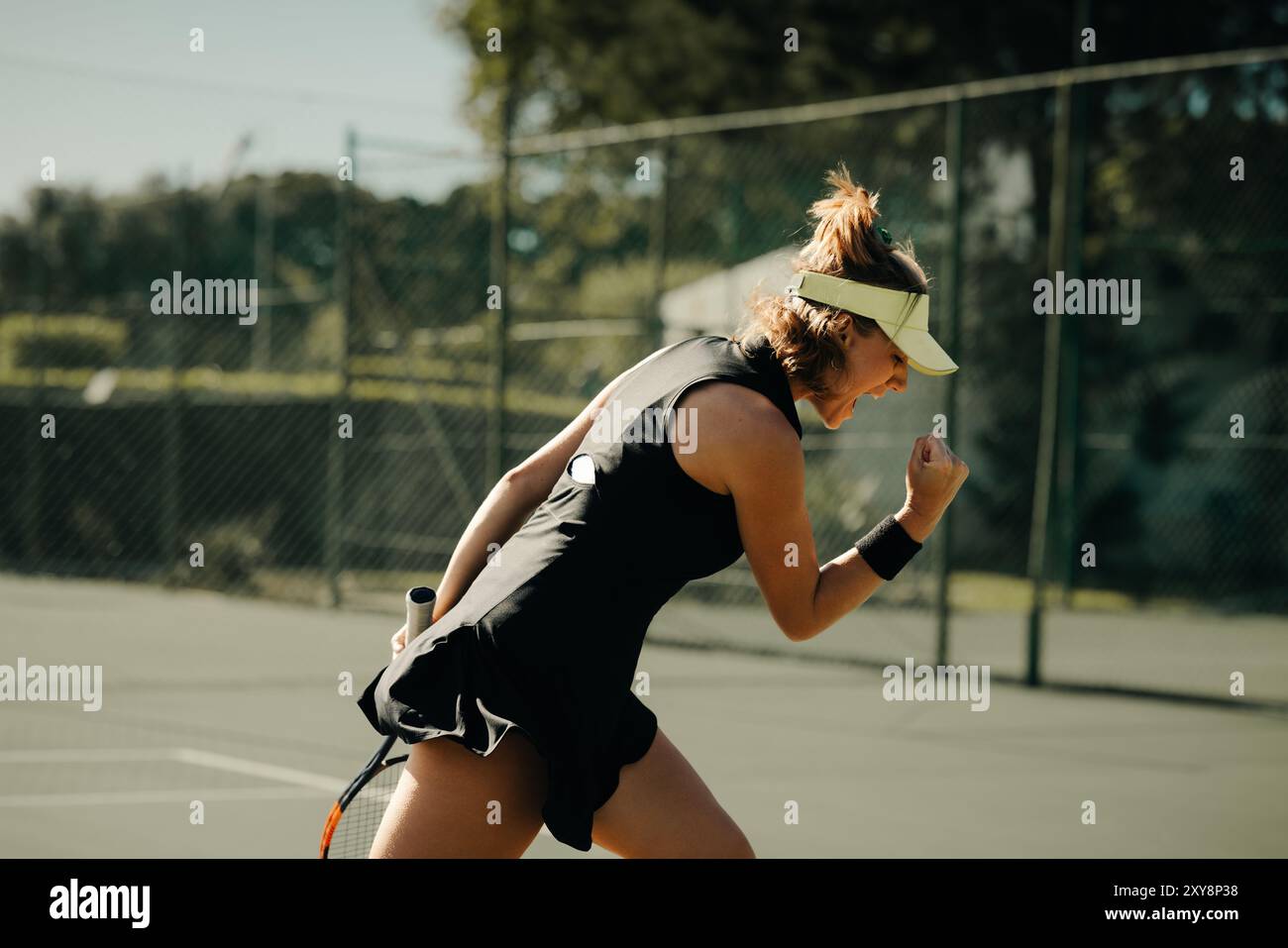 Female playing tennis, showing excitement and celebration with a fist ...