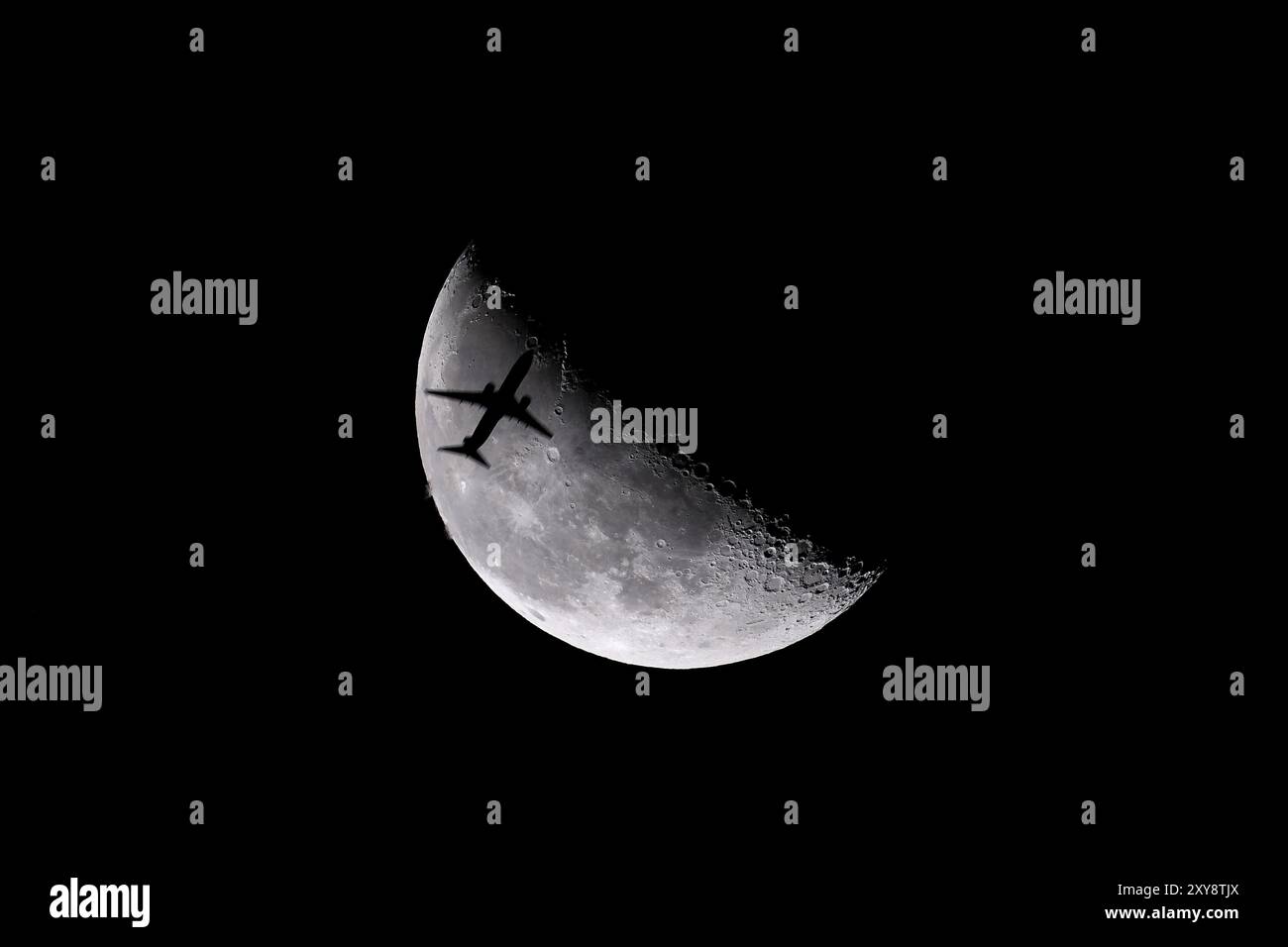 Airliner flying over the moon in the night sky. Travel concept Stock ...