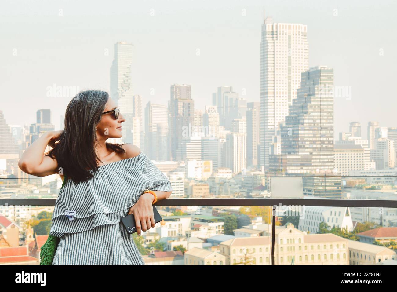 Young pretty woman tourist portrait enjoying Bangkok cityscape skyline ...