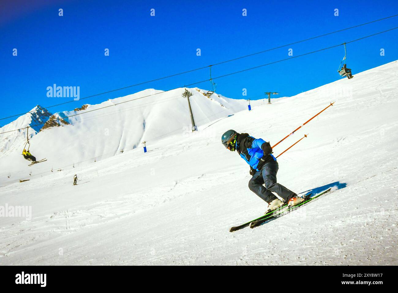 Side view male skier wear blue isolated on piste ski downhill fast ...