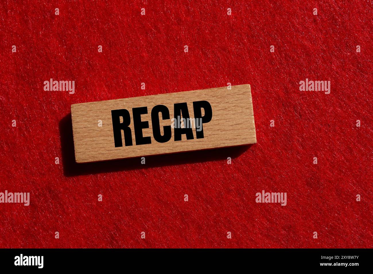 Recap word written on wooden block with red background. Conceptual ...