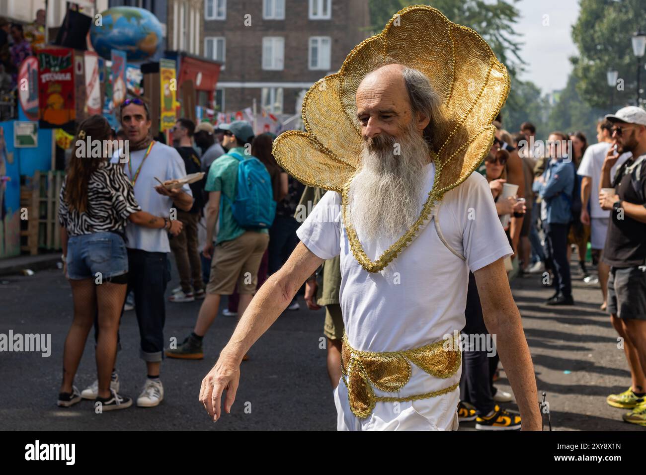 London, UK. 26th August, 2024. A performer wearing a gold costume ...