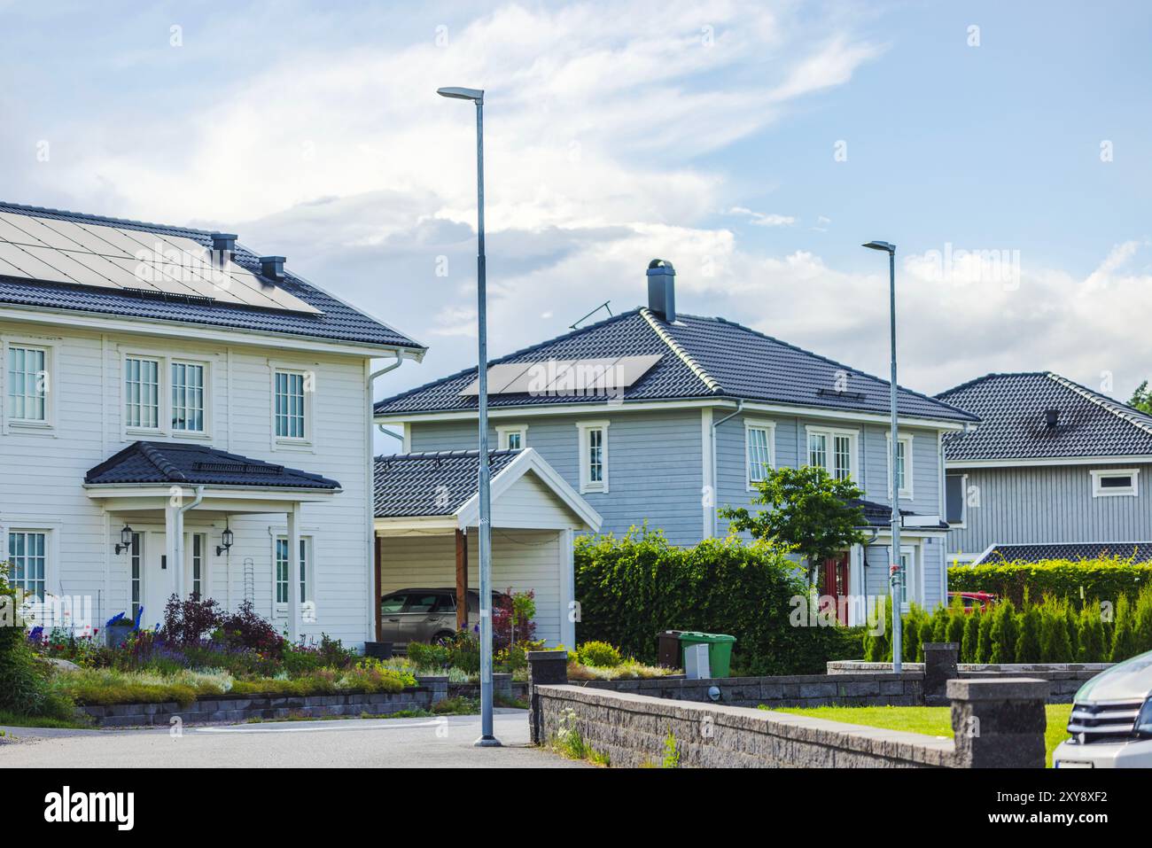 Residential village with two-story wooden villas featuring solar panels ...
