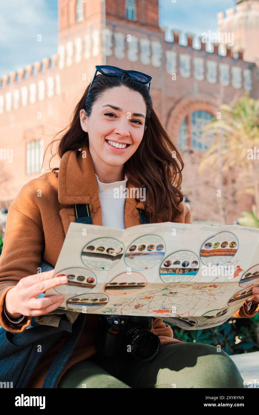 Vertical. tourist woman searching a location on a map. Happy female ...