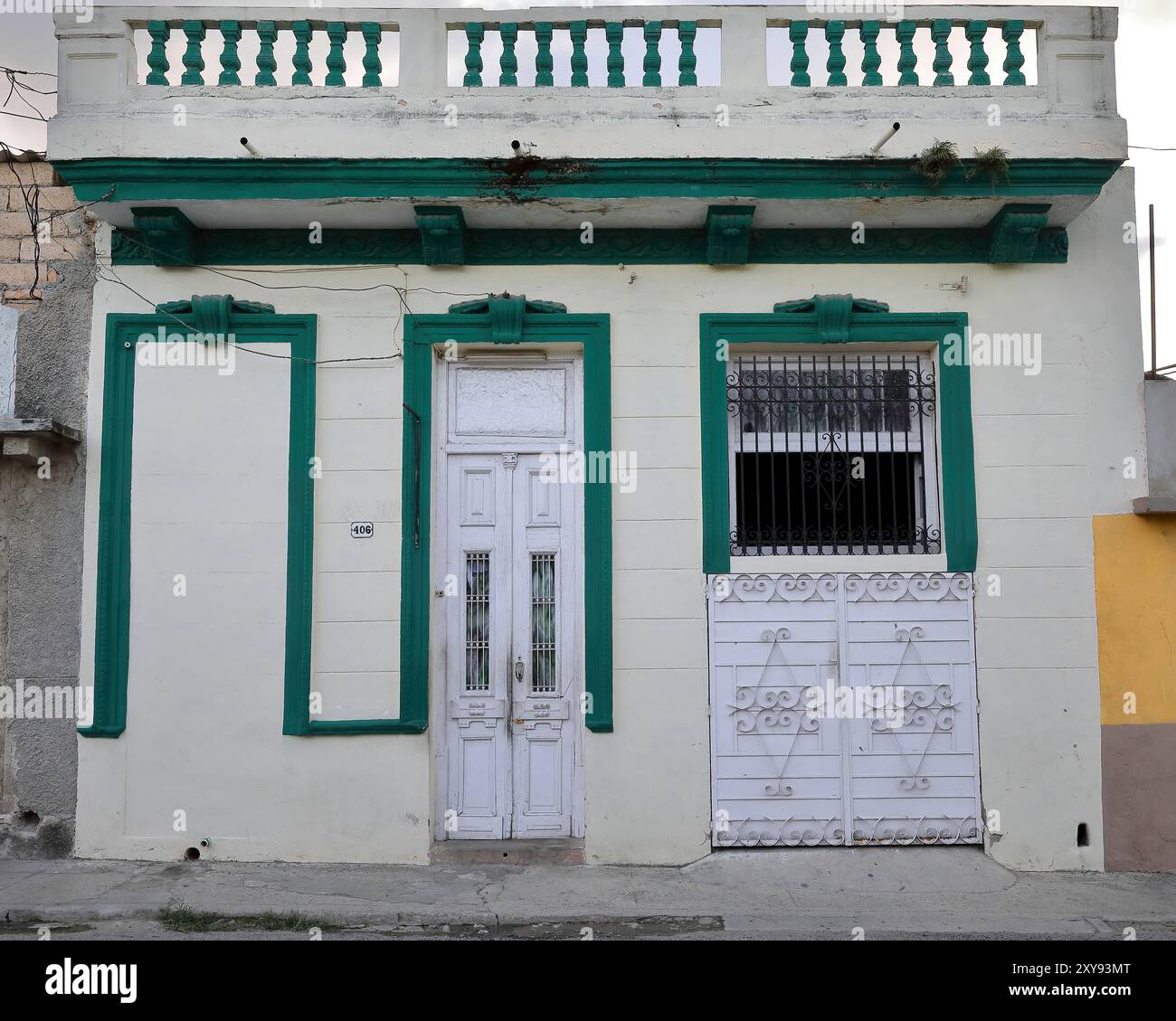 651 Ivory-white wall, green moldings, wood door, grille window, metal ...