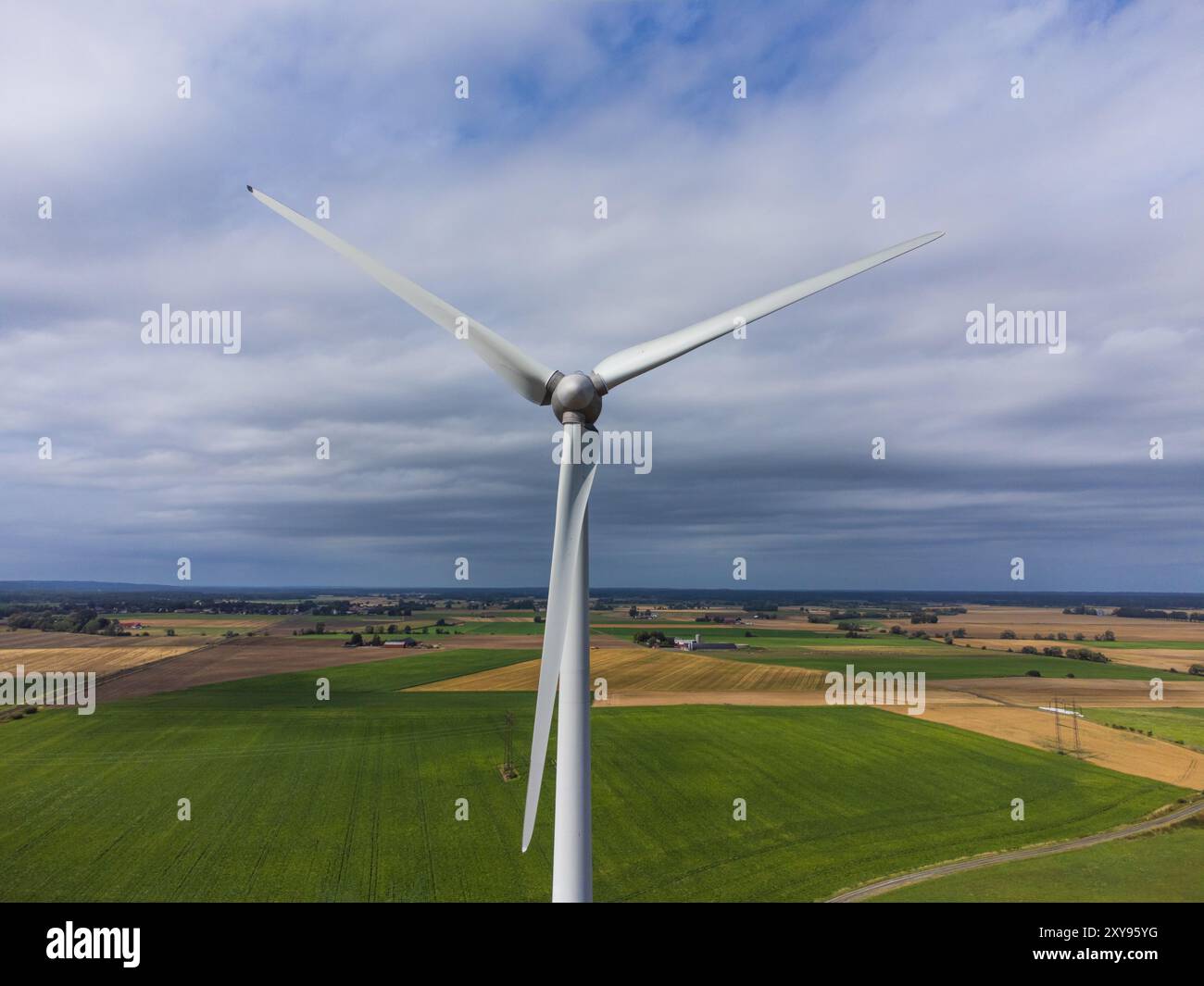 Aerial front view of a wind turbine in the wind. Sweden, summer, green ...