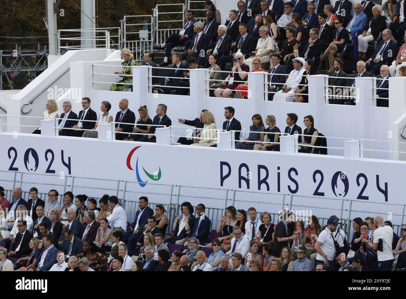 French President Emmanuel Macron points towards the stage as he sits ...