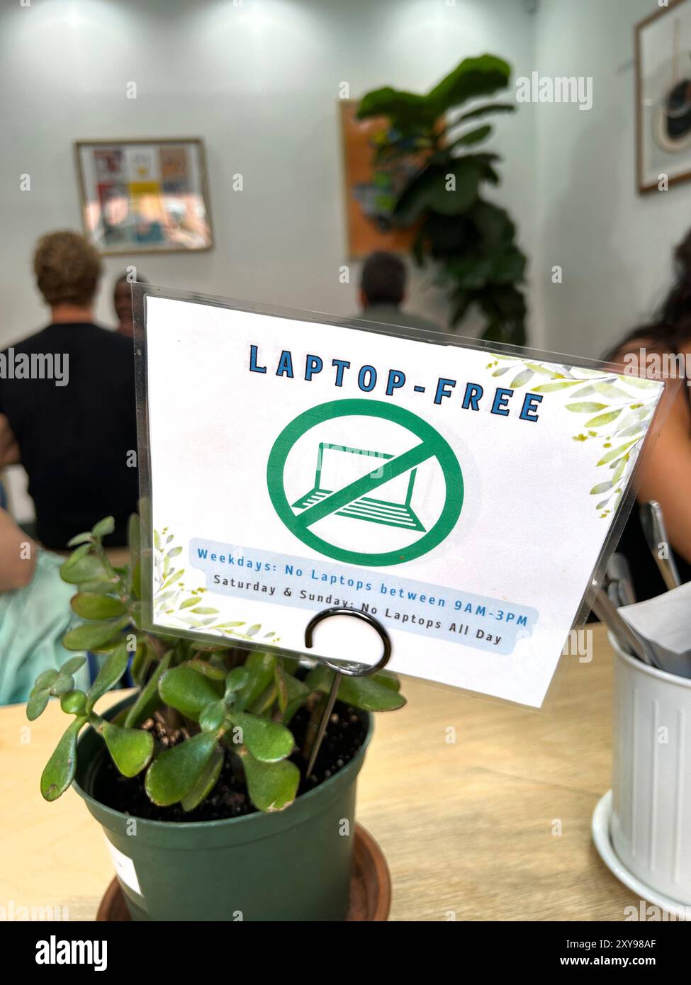 Laptop-Free Zone sign on café window Stock Photo - Alamy