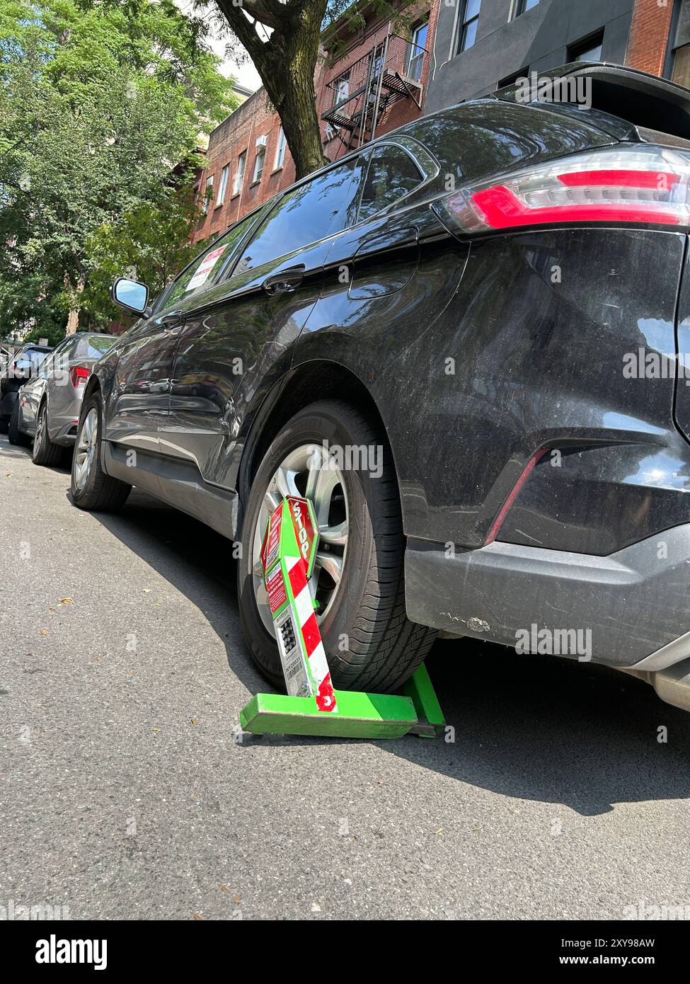 Wheel clamp device on rear car wheel Stock Photo - Alamy