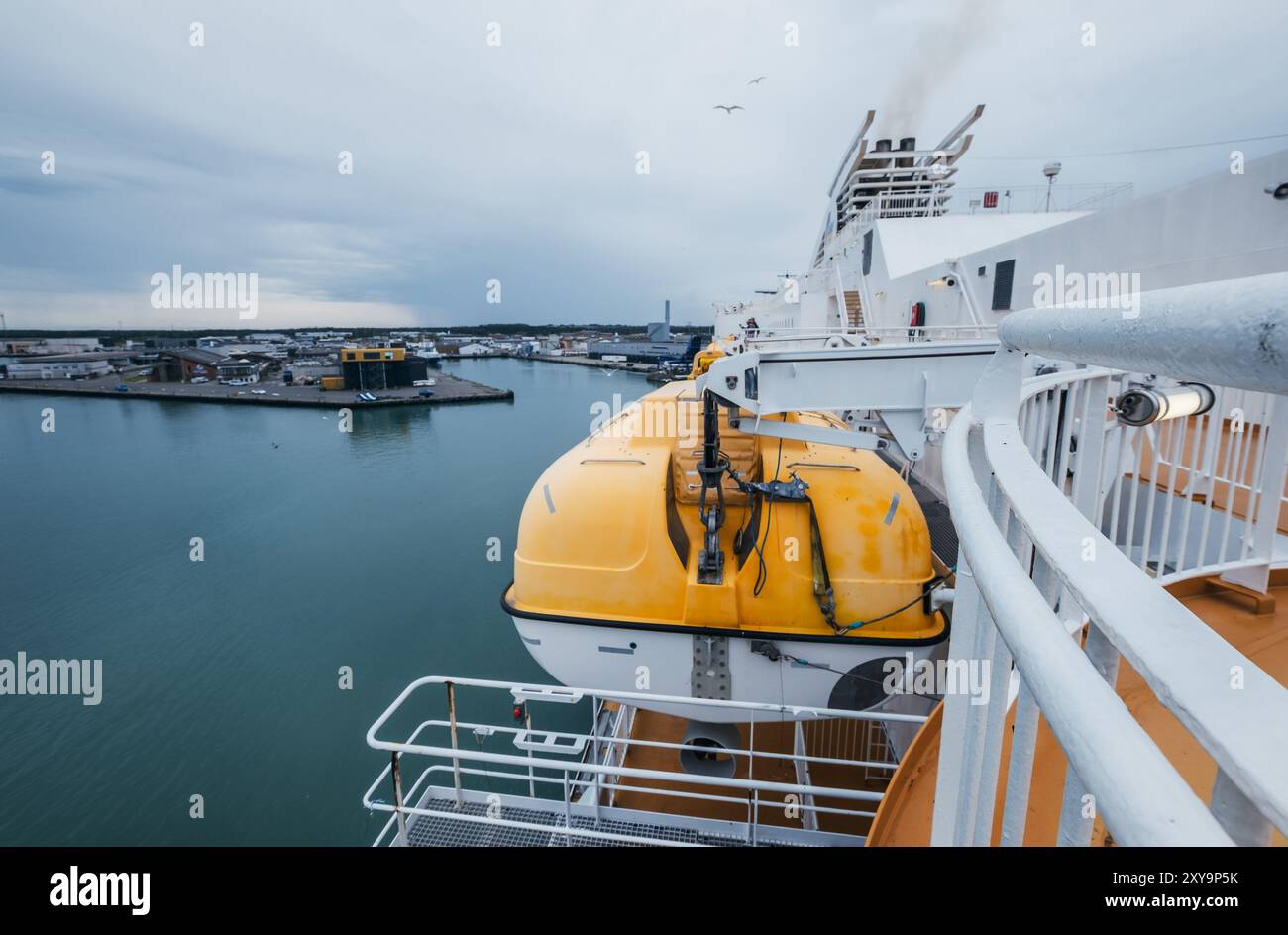 Norwegian ferry with its bright yellow rescue boat securely attached ...