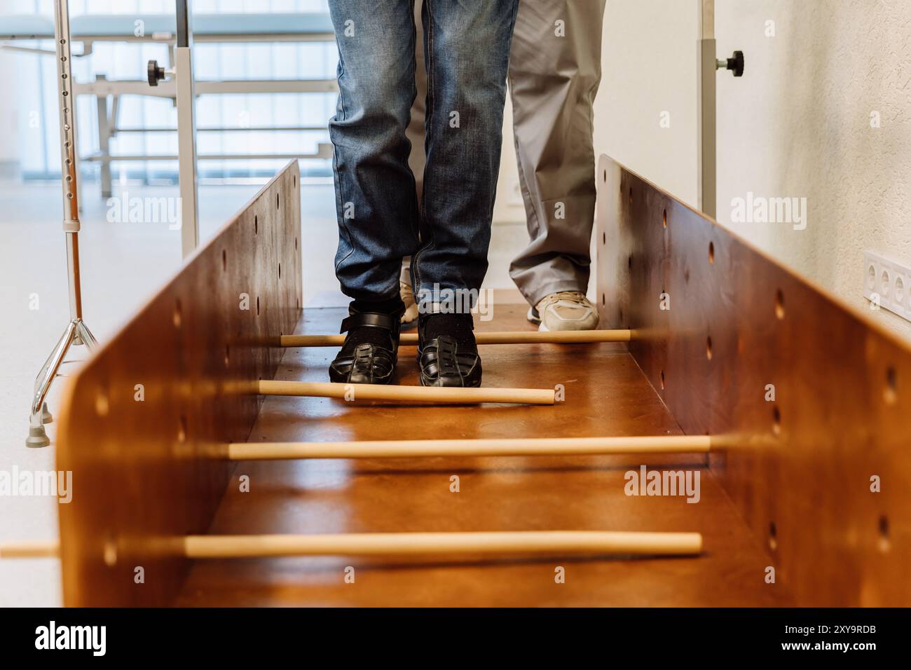 Therapist assisting patient with walking exercises during physical ...