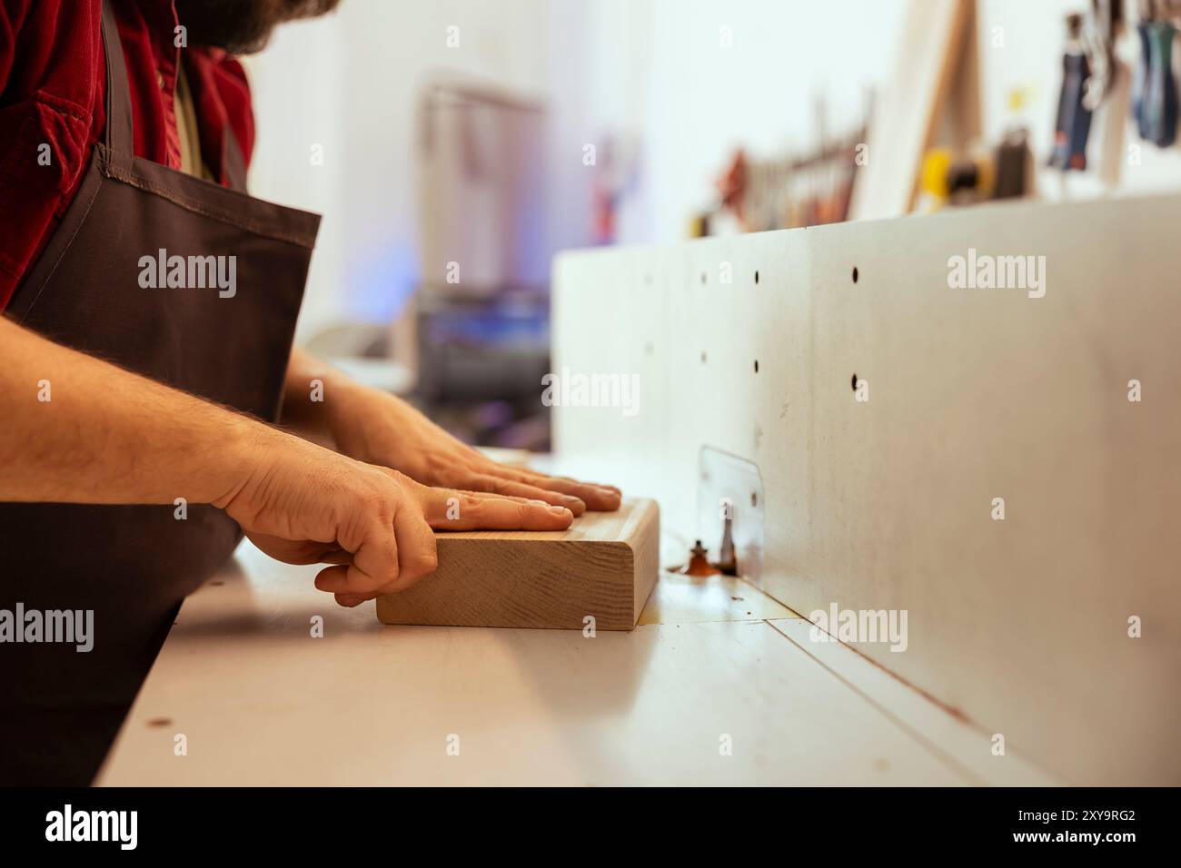 Woodworking professional operating wood shaper in assembly shop ...