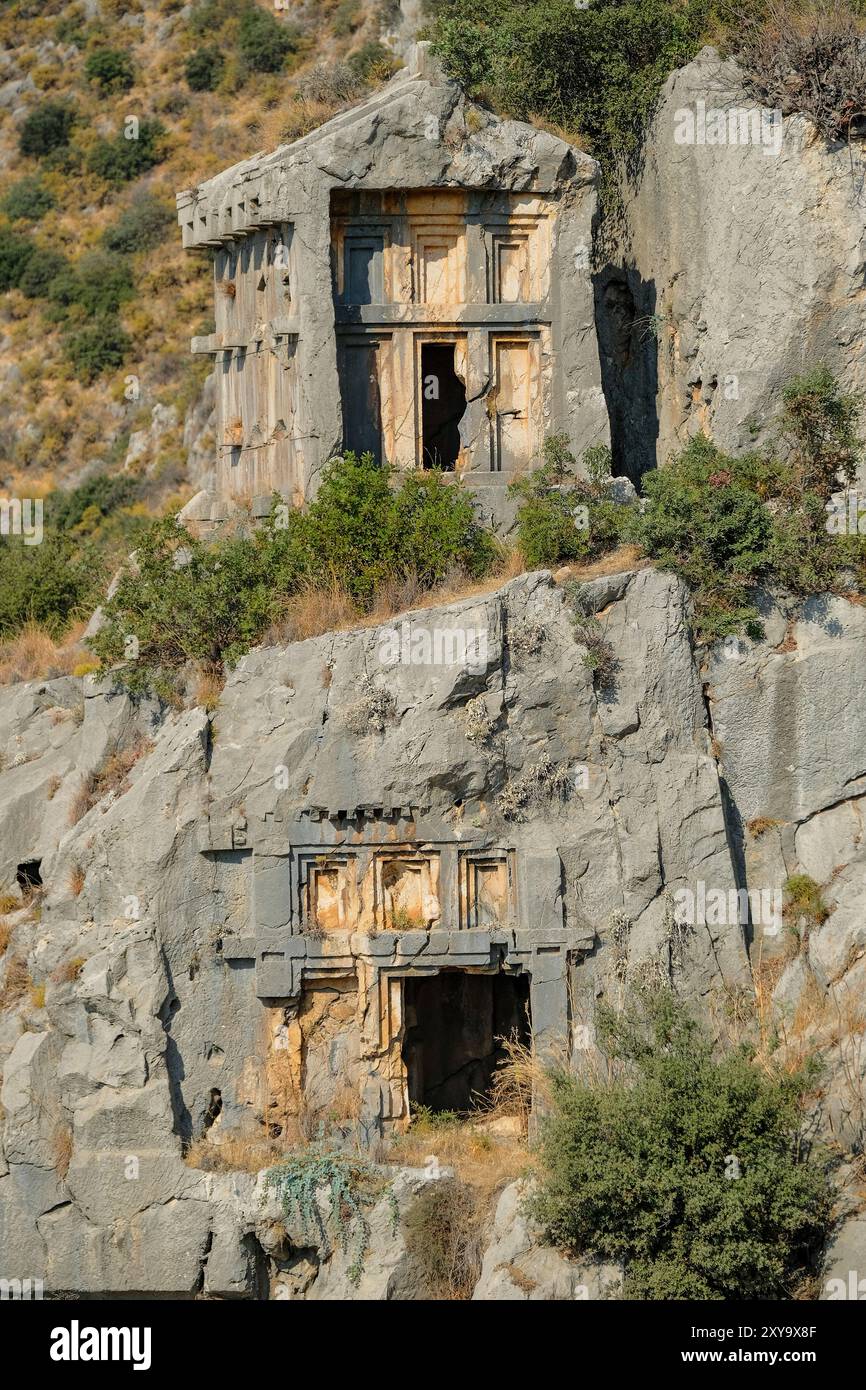 Demre, Turkey - August 24, 2024: Rock-cut tombs in the ruins of Myra ...