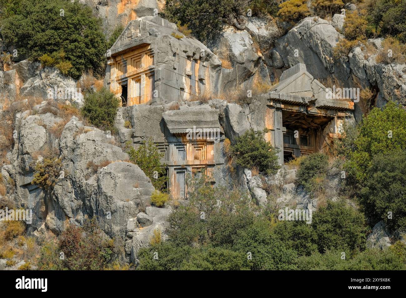 Demre, Turkey - August 24, 2024: Rock-cut tombs in the ruins of Myra ...
