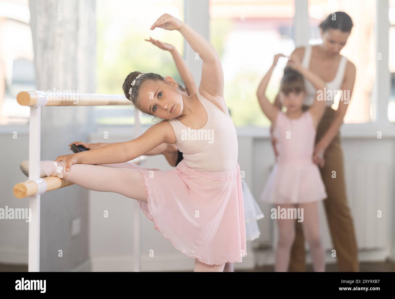 Ballet pose grand batman - little girls at a choreography lesson are ...
