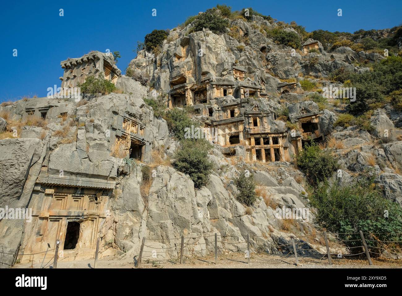 Demre, Turkey - August 24, 2024: Rock-cut tombs in the ruins of Myra ...