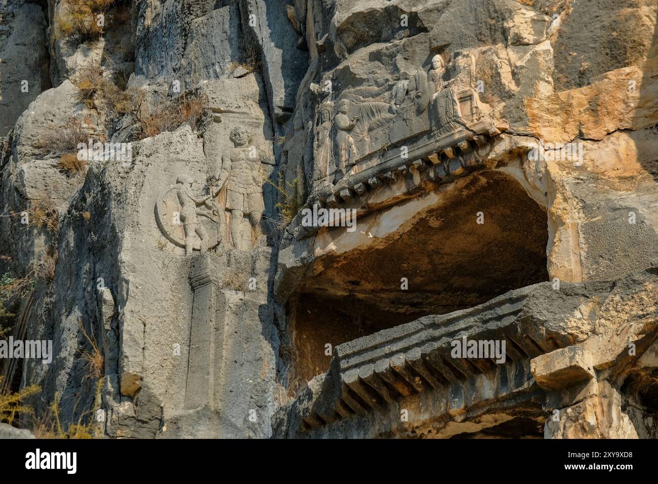Demre, Turkey - August 24, 2024: Rock-cut tombs in the ruins of Myra ...