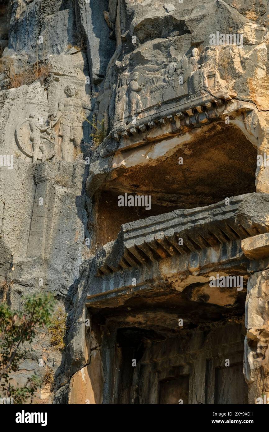 Demre, Turkey - August 24, 2024: Rock-cut tombs in the ruins of Myra ...