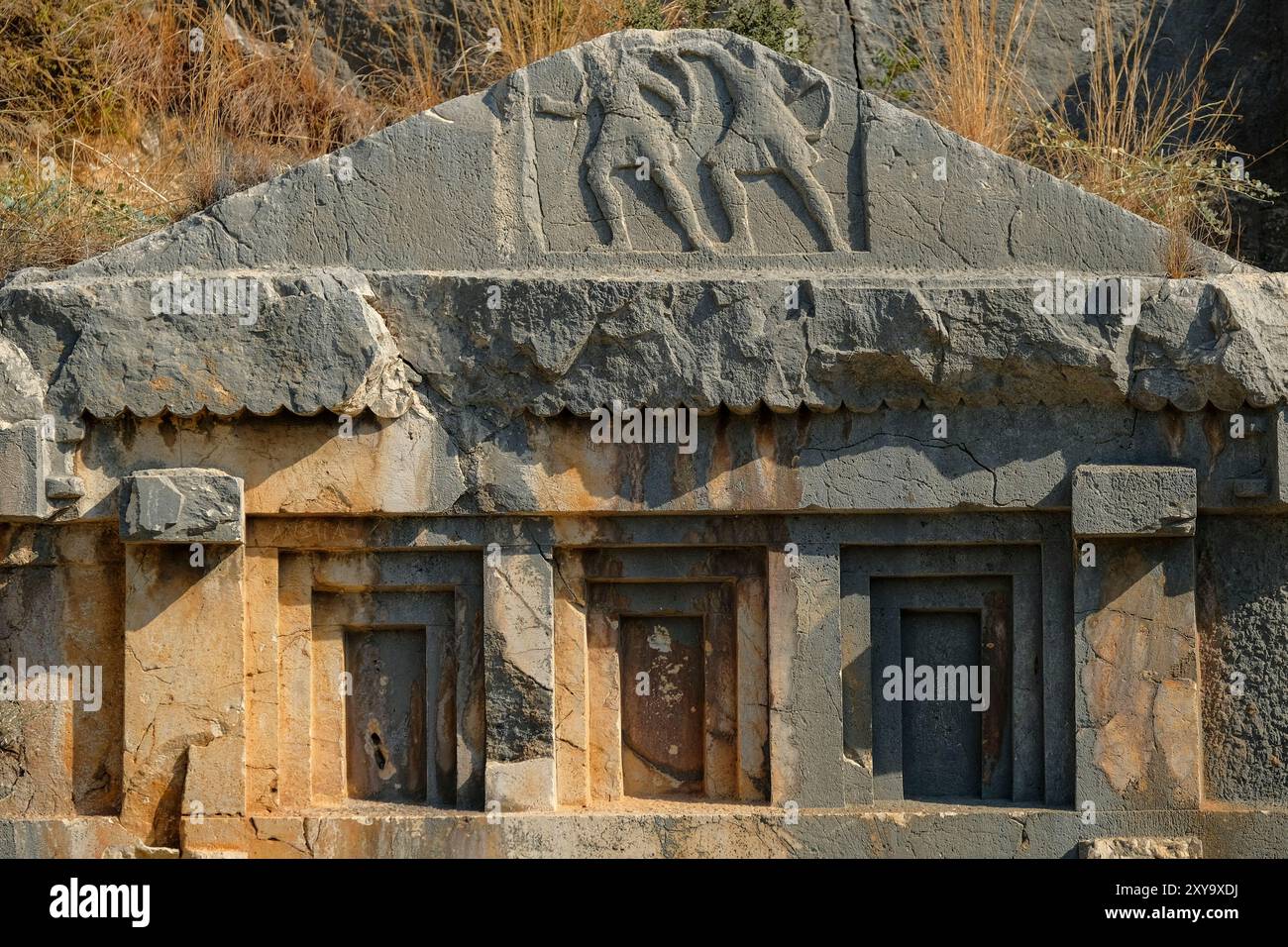 Demre, Turkey - August 24, 2024: Rock-cut tombs in the ruins of Myra ...