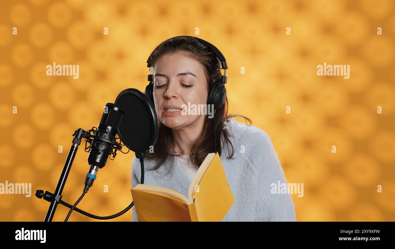 Voice actor reading book, recording for audiobook production using ...